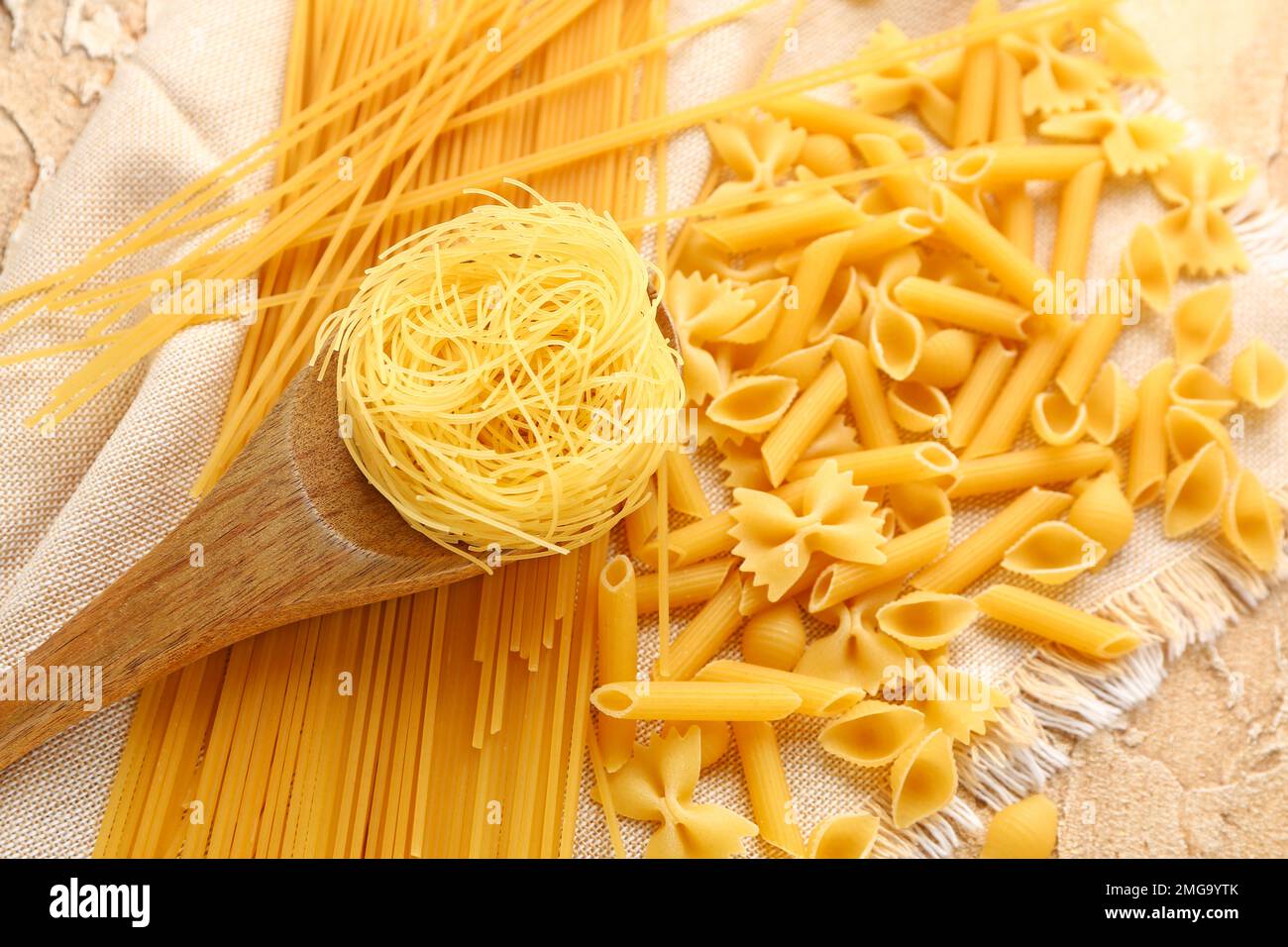 Different types of uncooked pasta on color table, closeup Stock Photo ...