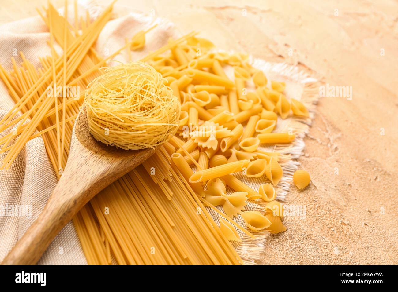 Different types of uncooked pasta on color table, closeup Stock Photo ...