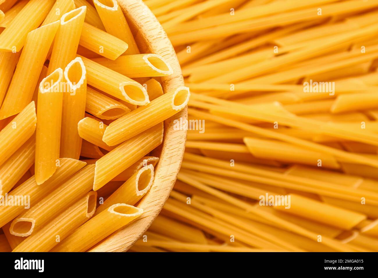 Bowl of raw penne pasta, closeup Stock Photo - Alamy