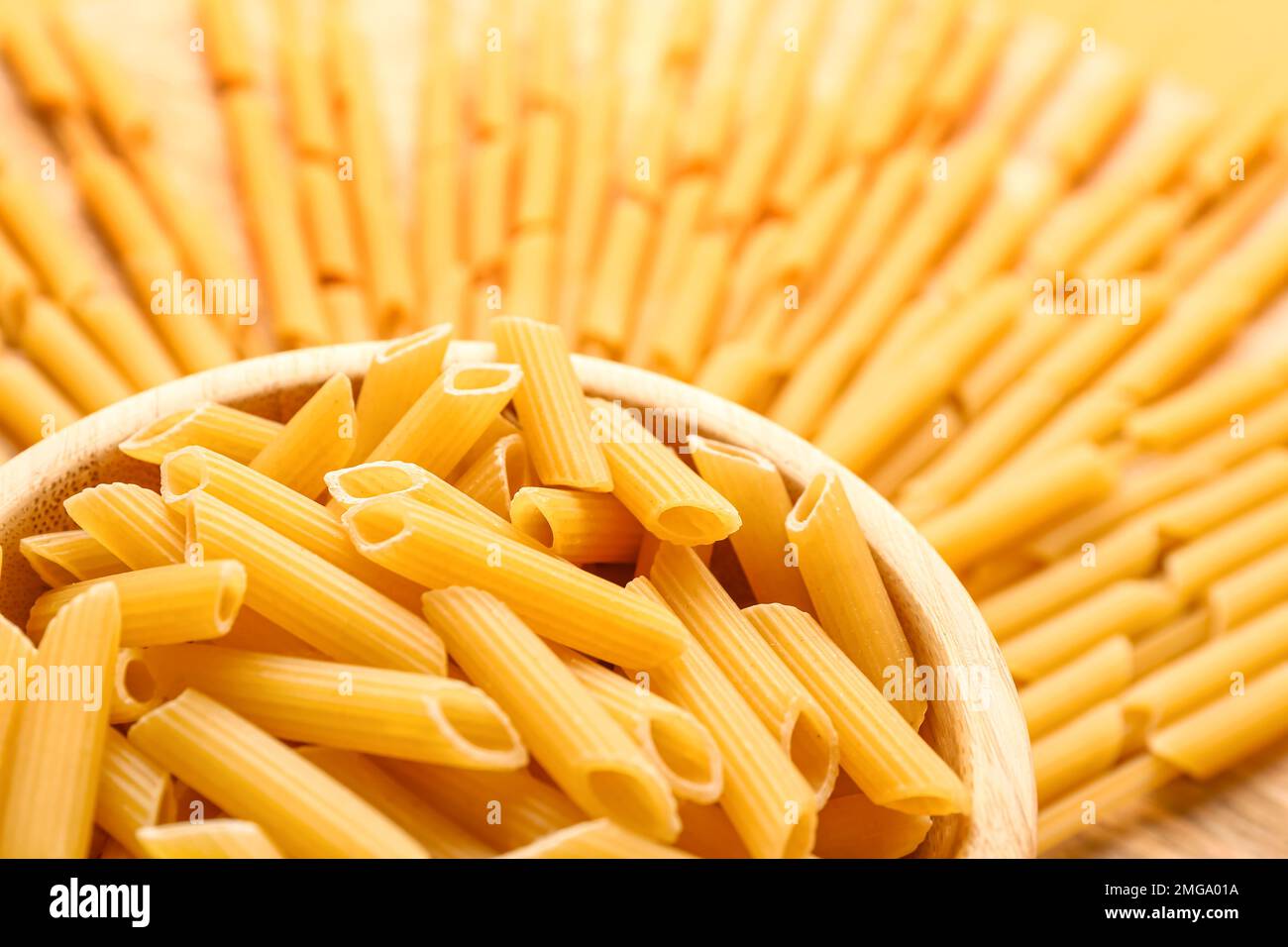 Bowl of raw penne pasta, closeup Stock Photo - Alamy
