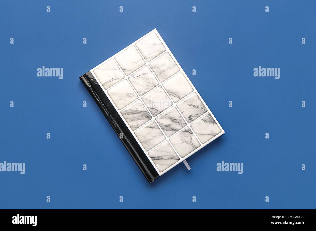 Stylish notebook on blue background Stock Photo - Alamy