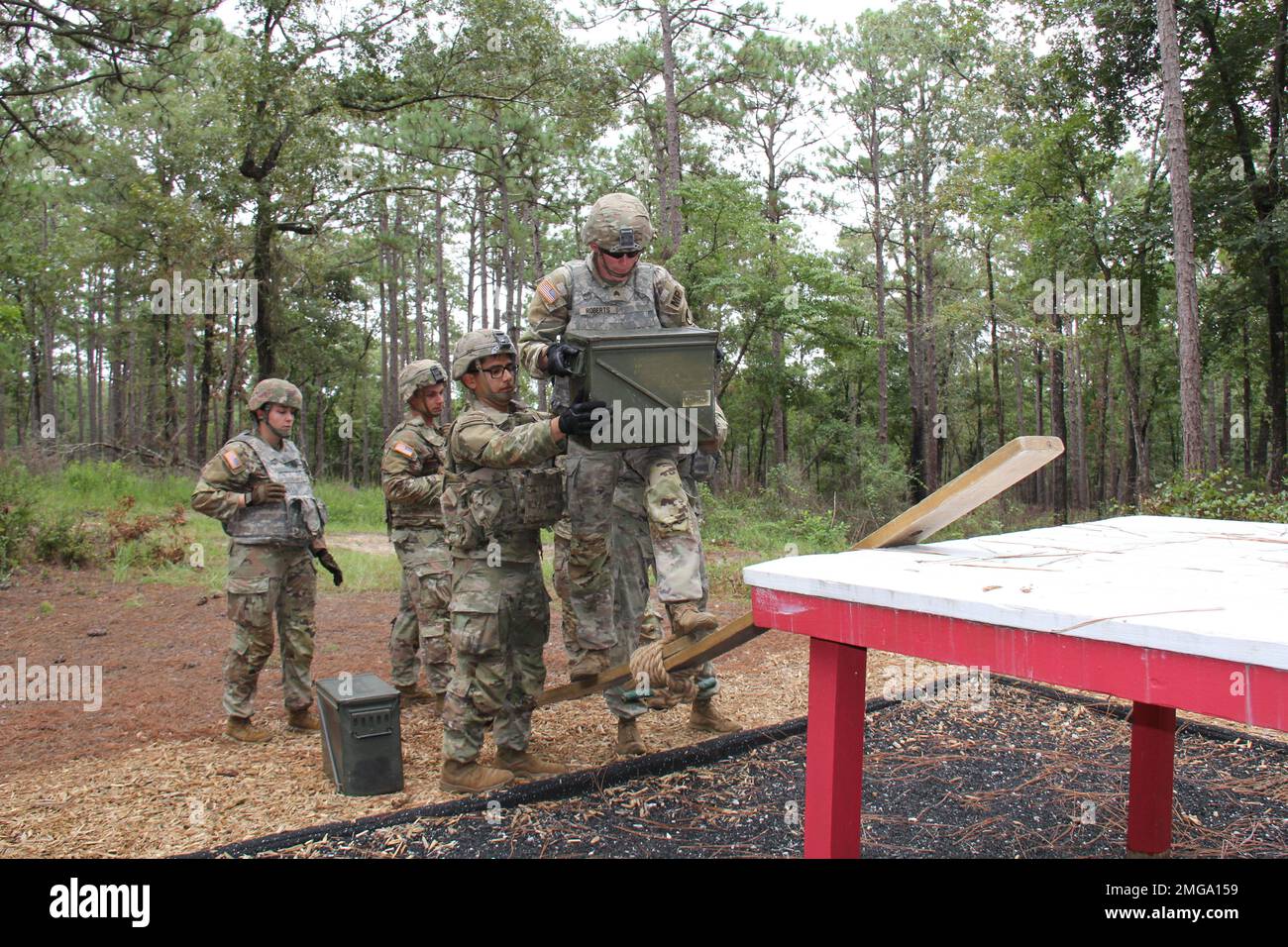 SGT Collin Roberts and SPC Matthew Ruiz move an ammo box at the ...