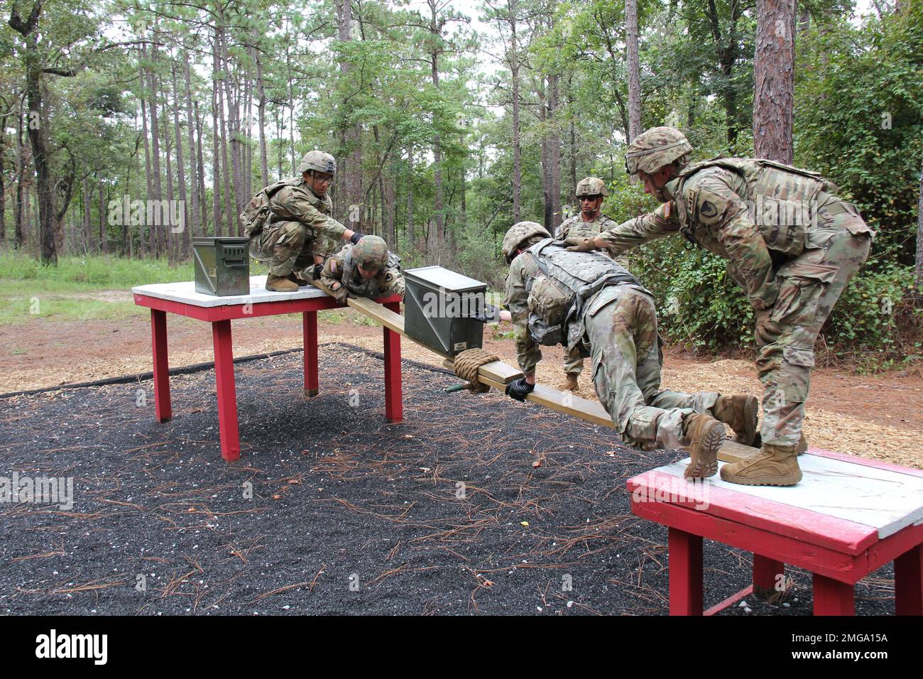 SPC Alyssa Reyes passes an ammo box to SGT Collin Roberts at the ...