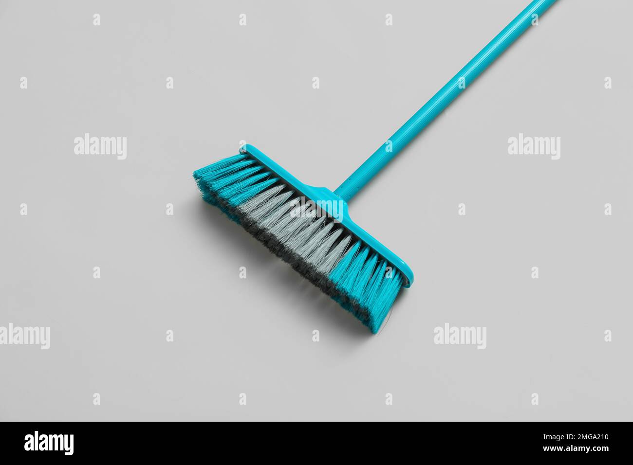 Blue sweeping broom on white background Stock Photo - Alamy