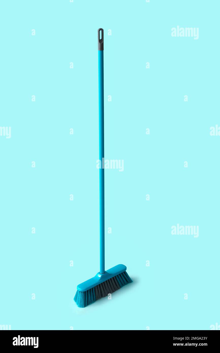 Blue plastic broom on color background Stock Photo - Alamy