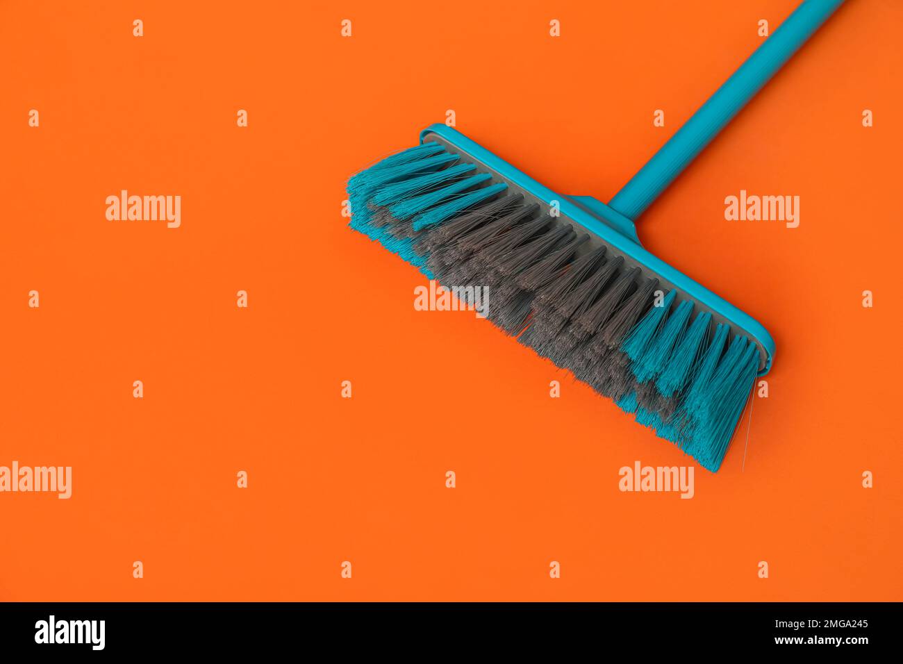 Blue broom for cleaning on color background Stock Photo - Alamy
