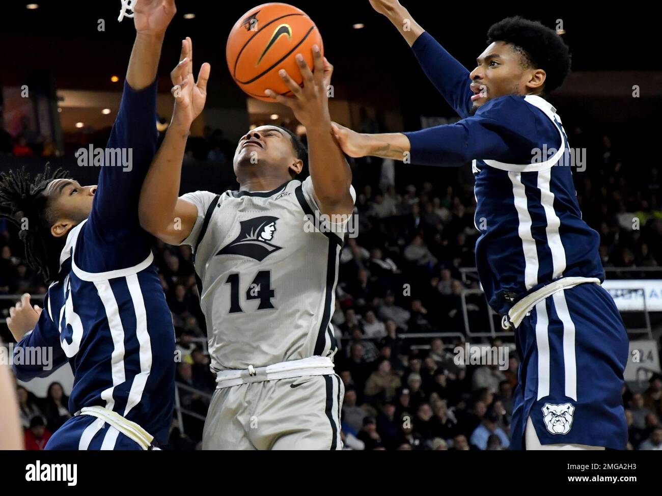 Butler's Jayden Taylor, left, and Jalen Thomas, right, put the squeeze ...