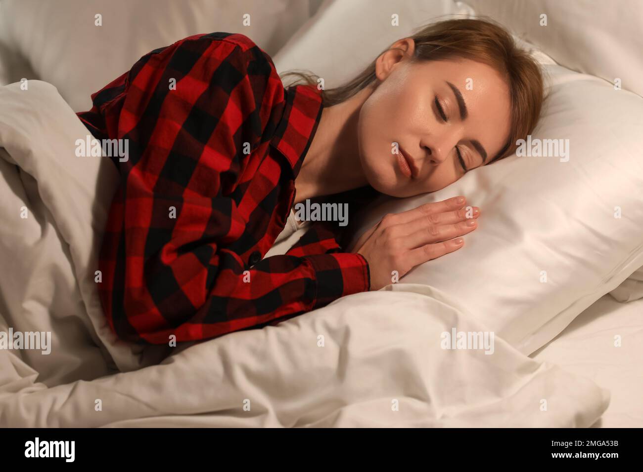 Beautiful woman sleeping in bed at night Stock Photo - Alamy