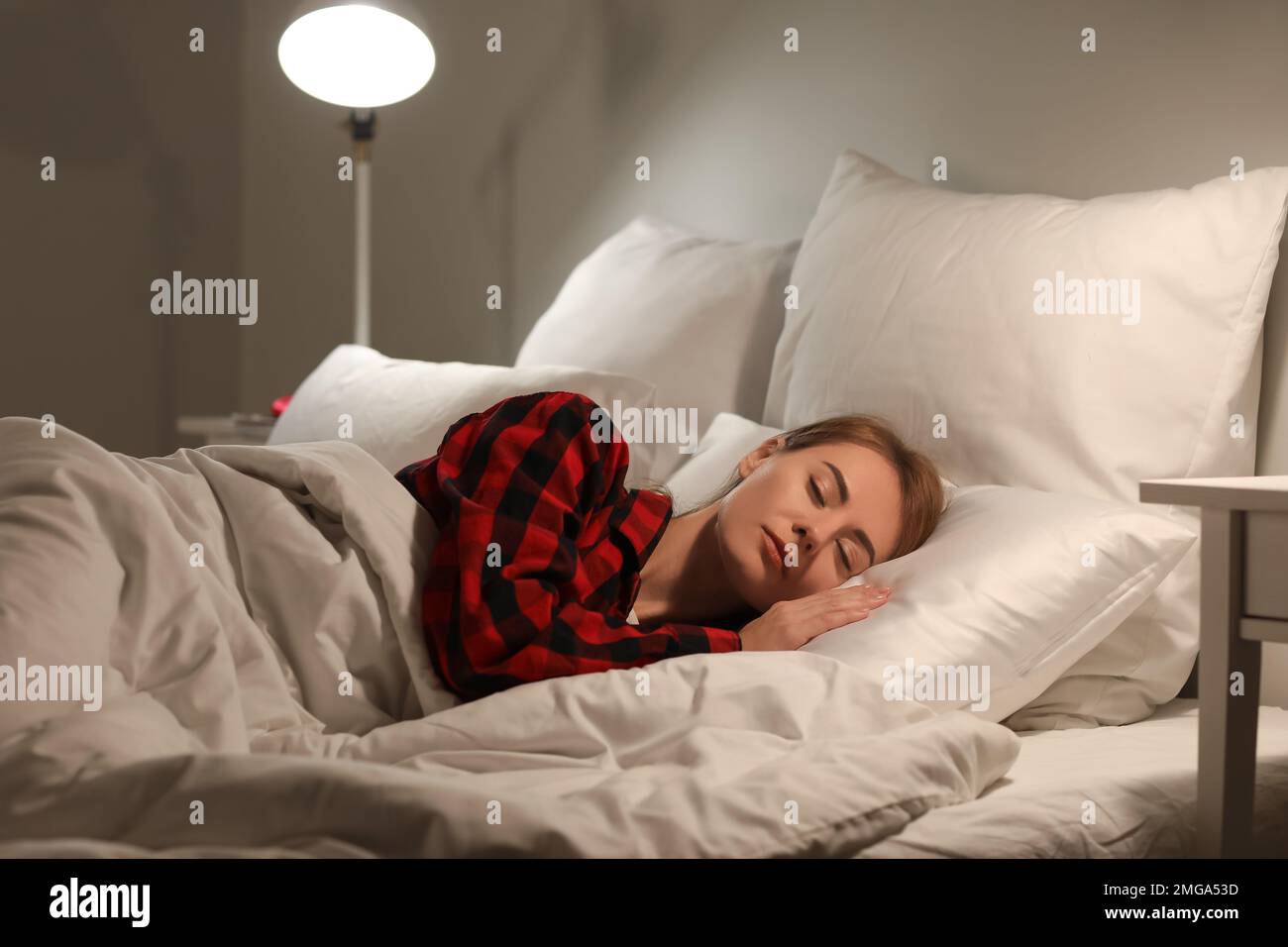 Beautiful woman sleeping in bed at night Stock Photo - Alamy