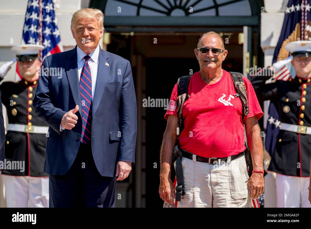 President Donald Trump gives a thumbs up as he poses for photographs ...
