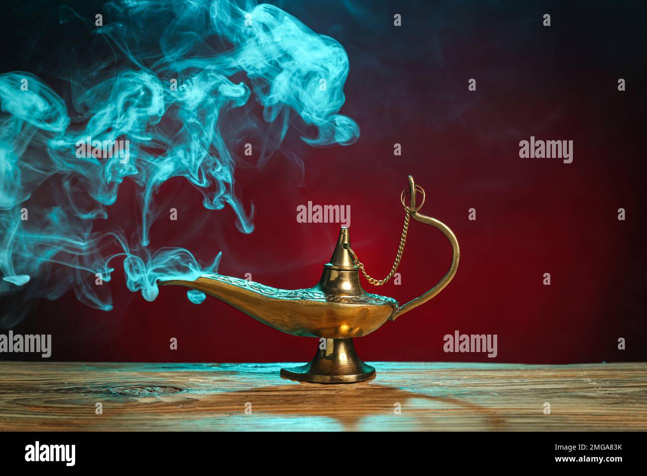Aladdin lamp of wishes with smoke for Ramadan on table against dark red background Stock Photo ...