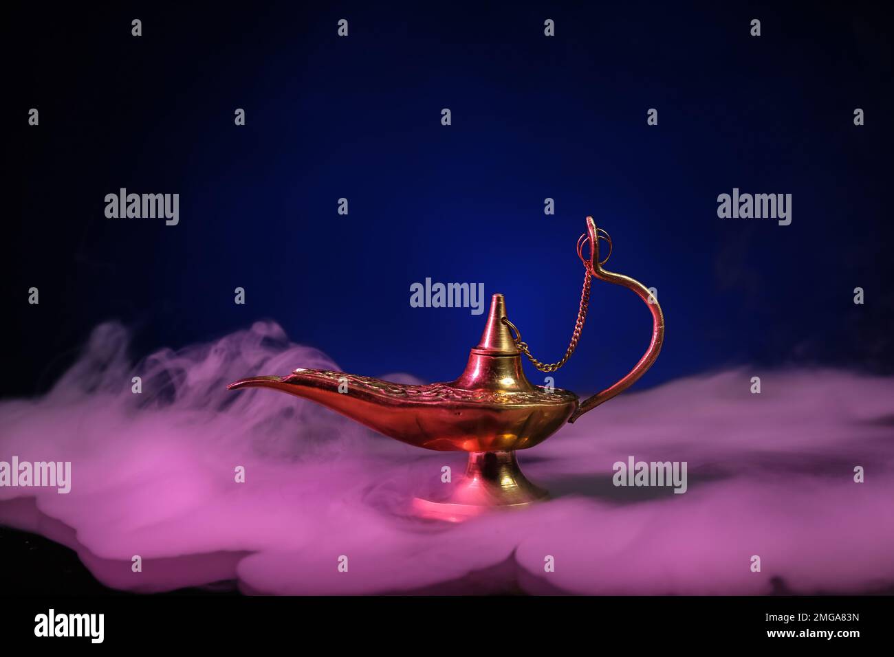 Aladdin lamp of wishes with smoke for Ramadan on table against dark ...