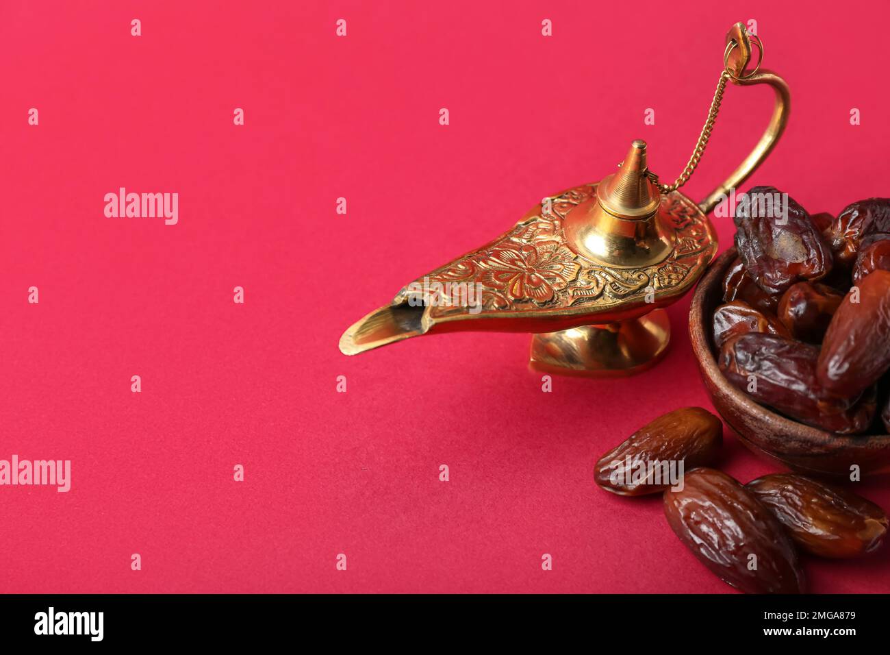 Aladdin lamp of wishes and dates for Ramadan on red background Stock ...