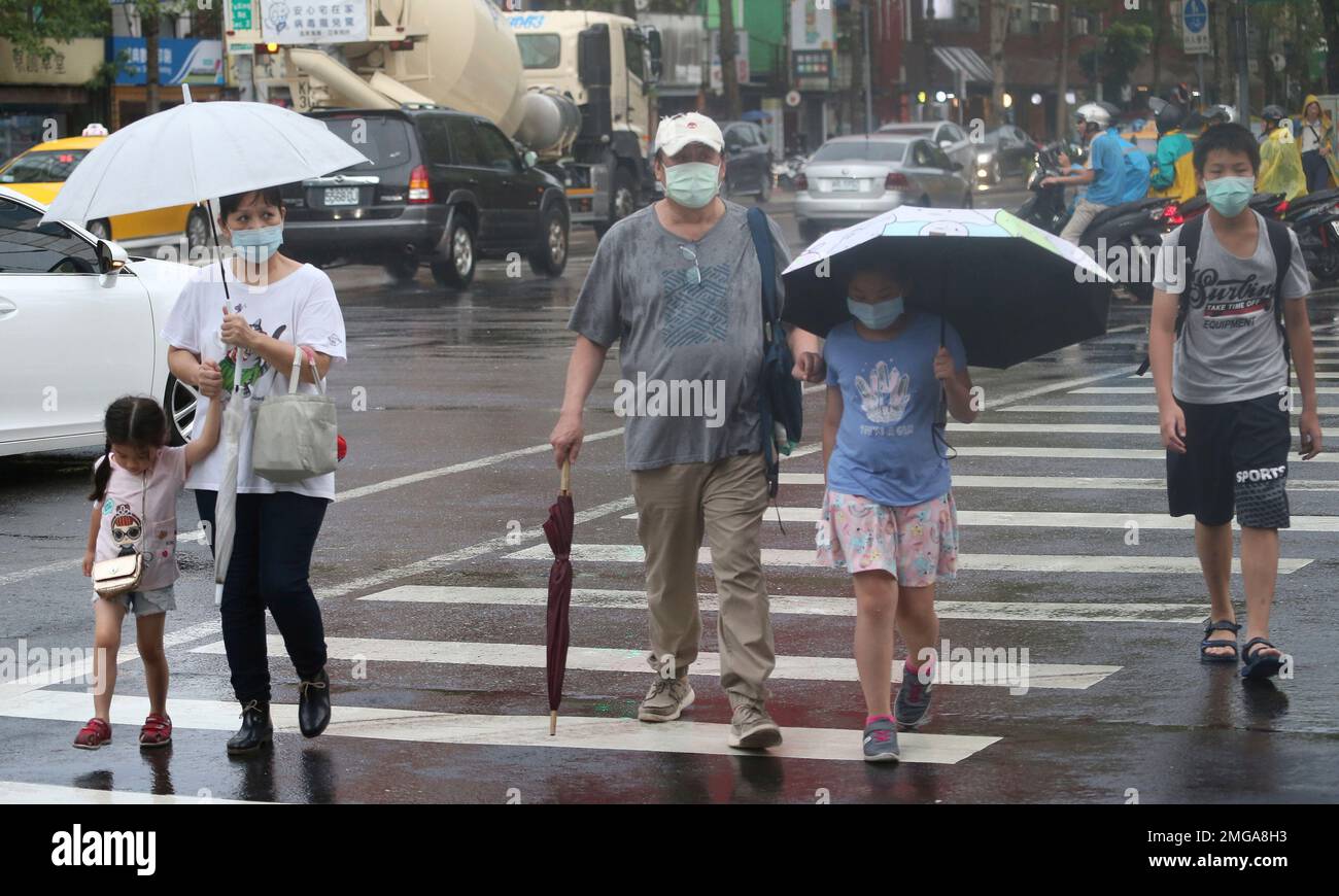People wear face masks to protect against the spread of the coronavirus ...