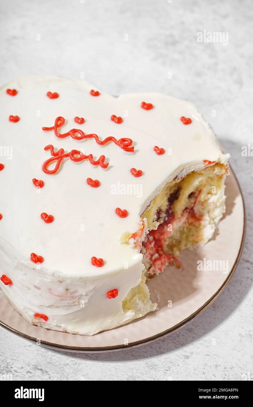 Plate with heart-shaped bento cake on white background. Valentine's Day ...