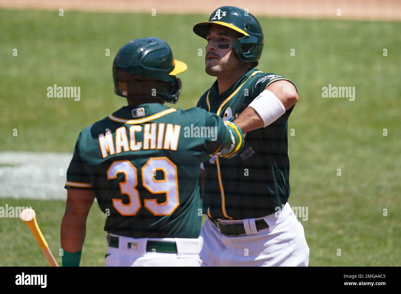 Oakland Athletics' Ramon Laureano, right, is congratulated by Vimael ...