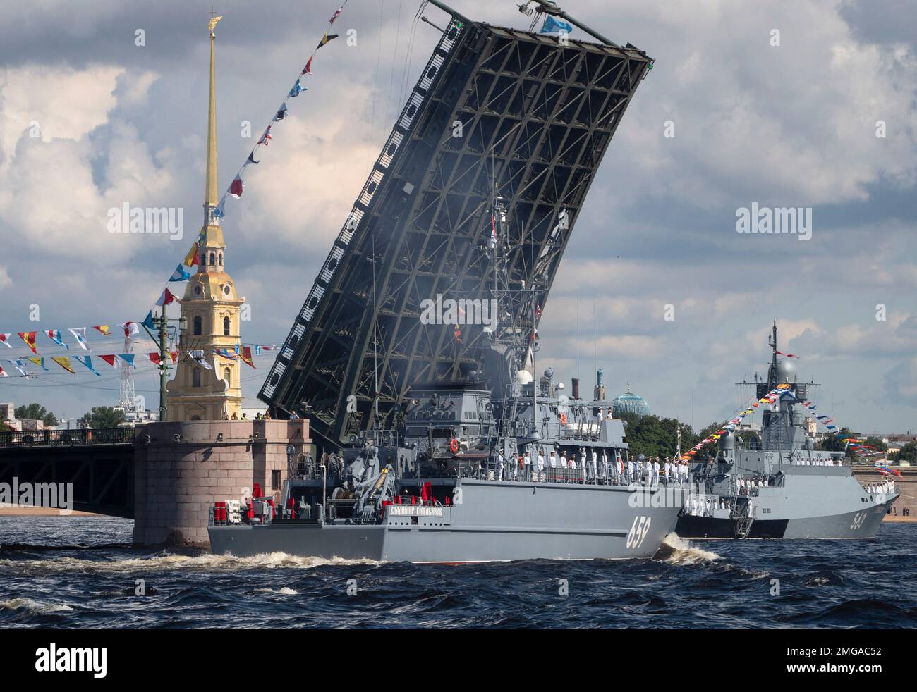 Warships pass the Dvortsovy (Palace) drawbridge rising above the Neva ...