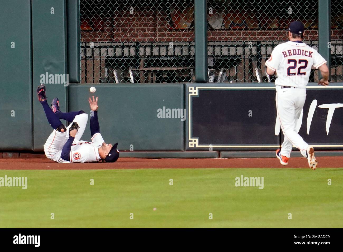 Houston Astros center fielder George Springer, left, tosses the ball to ...
