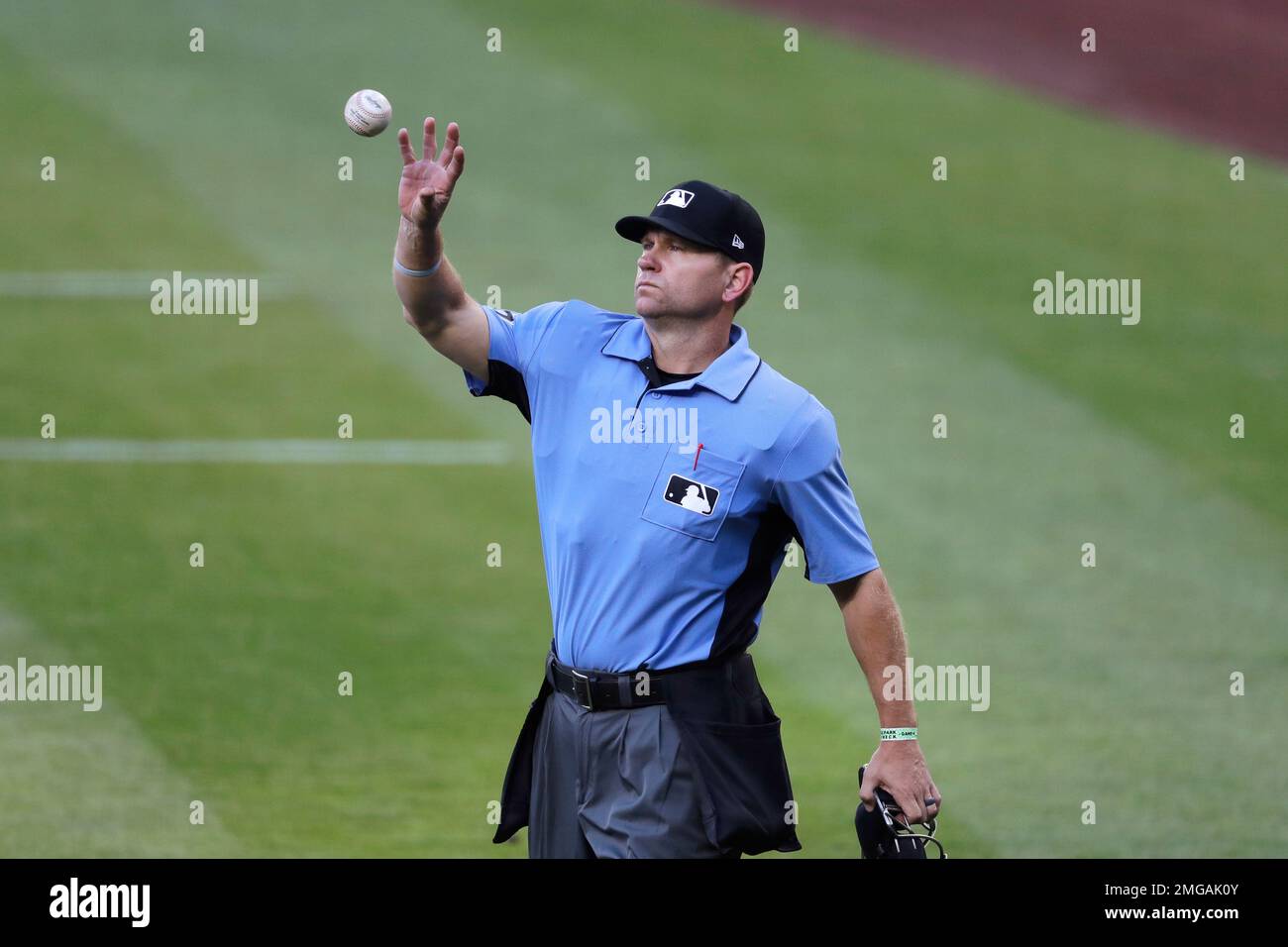 Umpire Tripp Gibson reaches for a ball during a Seattle Mariners ...