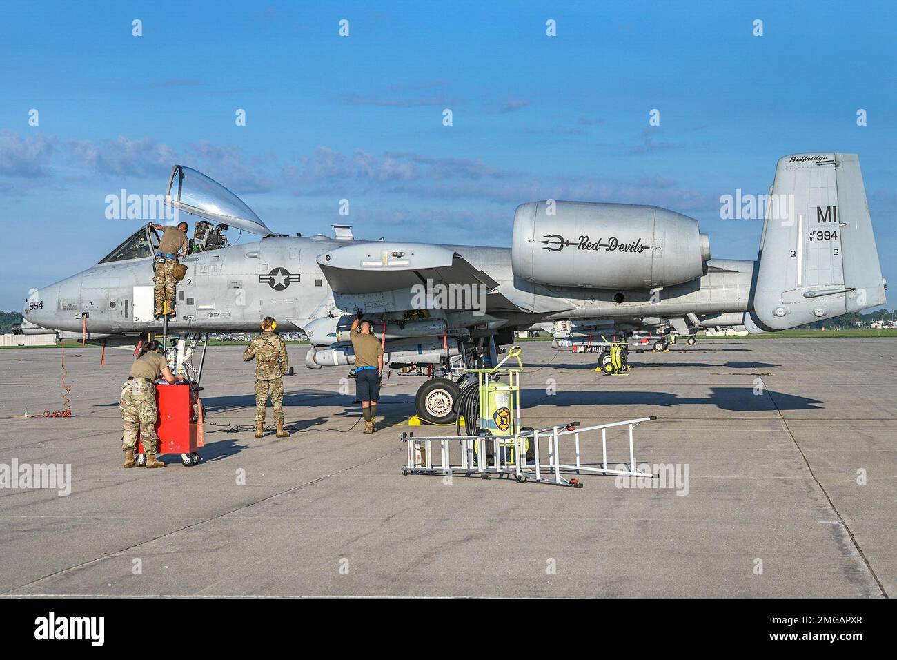 A 127th Aircraft Maintenance Squadron weapons load crew performs a ...