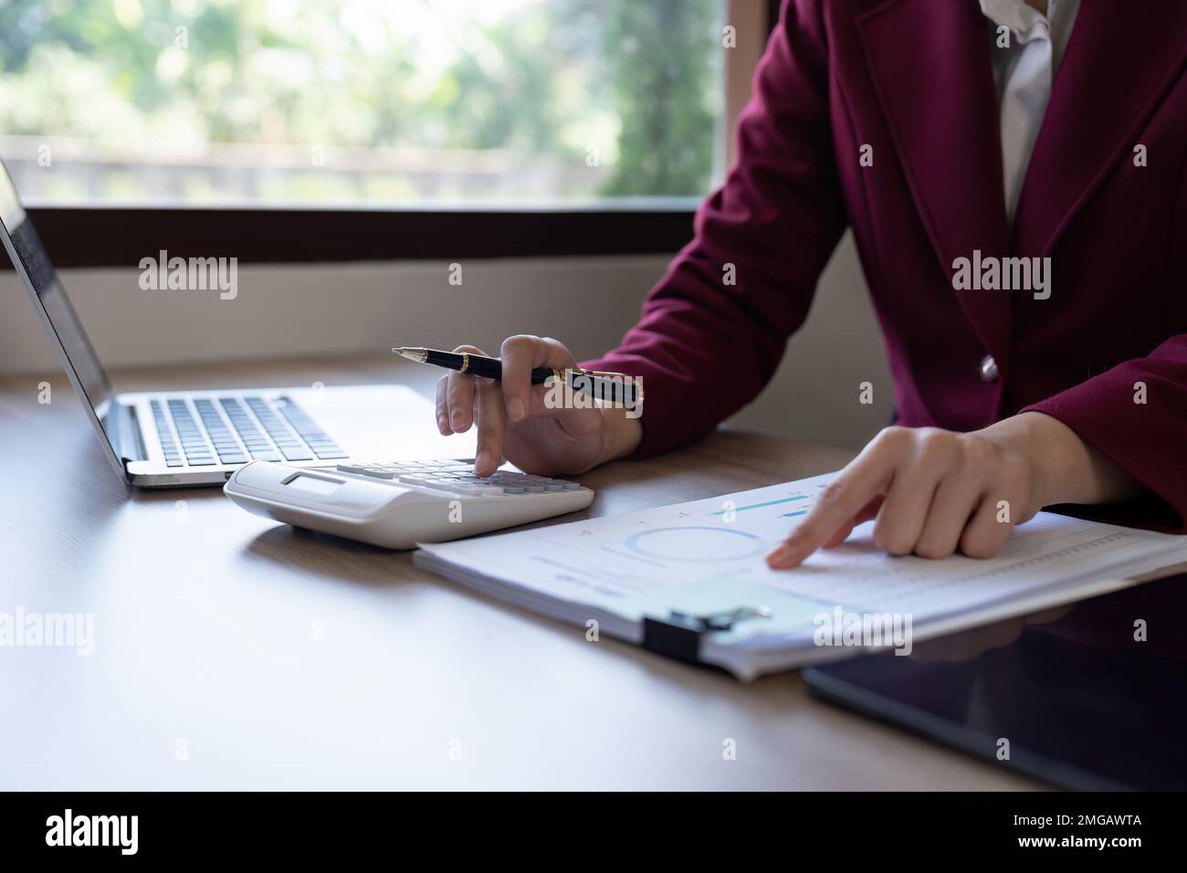 Close up of businessman or accountant hand holding pen working on ...