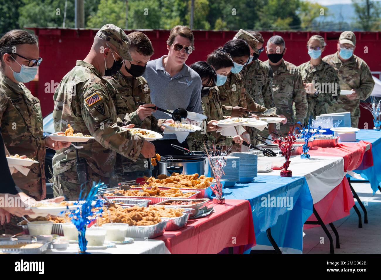 Volunteers with The Health Wagon organize a potluck lunch for U.S ...