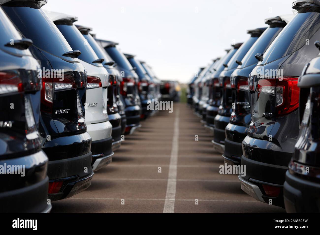 Long rows of unsold 2020 Pilot sports-utility vehicles sit at a Honda ...