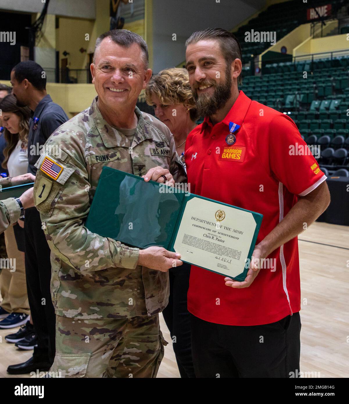 Chris Pastor, logistics deputy, Wounded Warrior Regiment, receives the ...