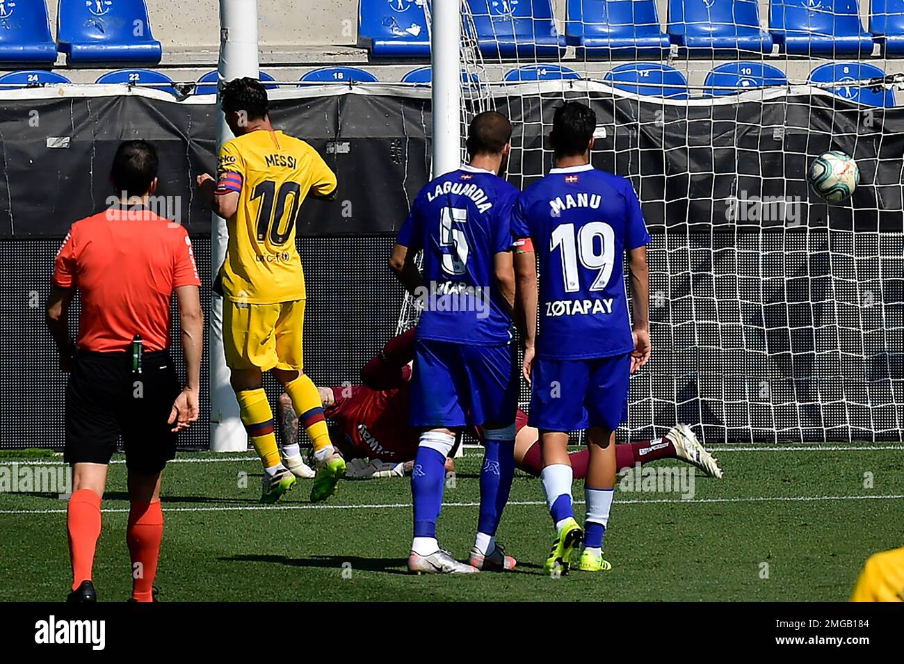 Barcelona's Lionel Messi, left, scores against Alaves during the ...