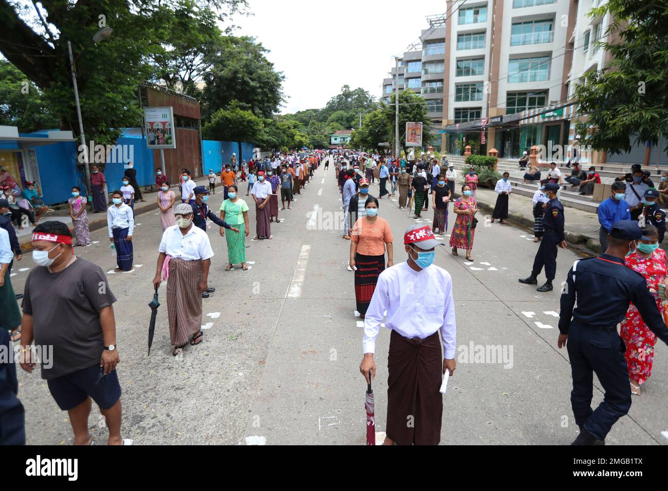 People line up on a road to salute at the Martyrs Mausoleum marking the ...