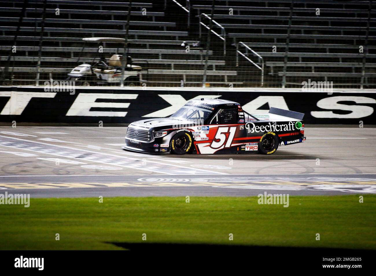 Kyle Busch heads down the front stretch during a NASCAR Trucks race at ...