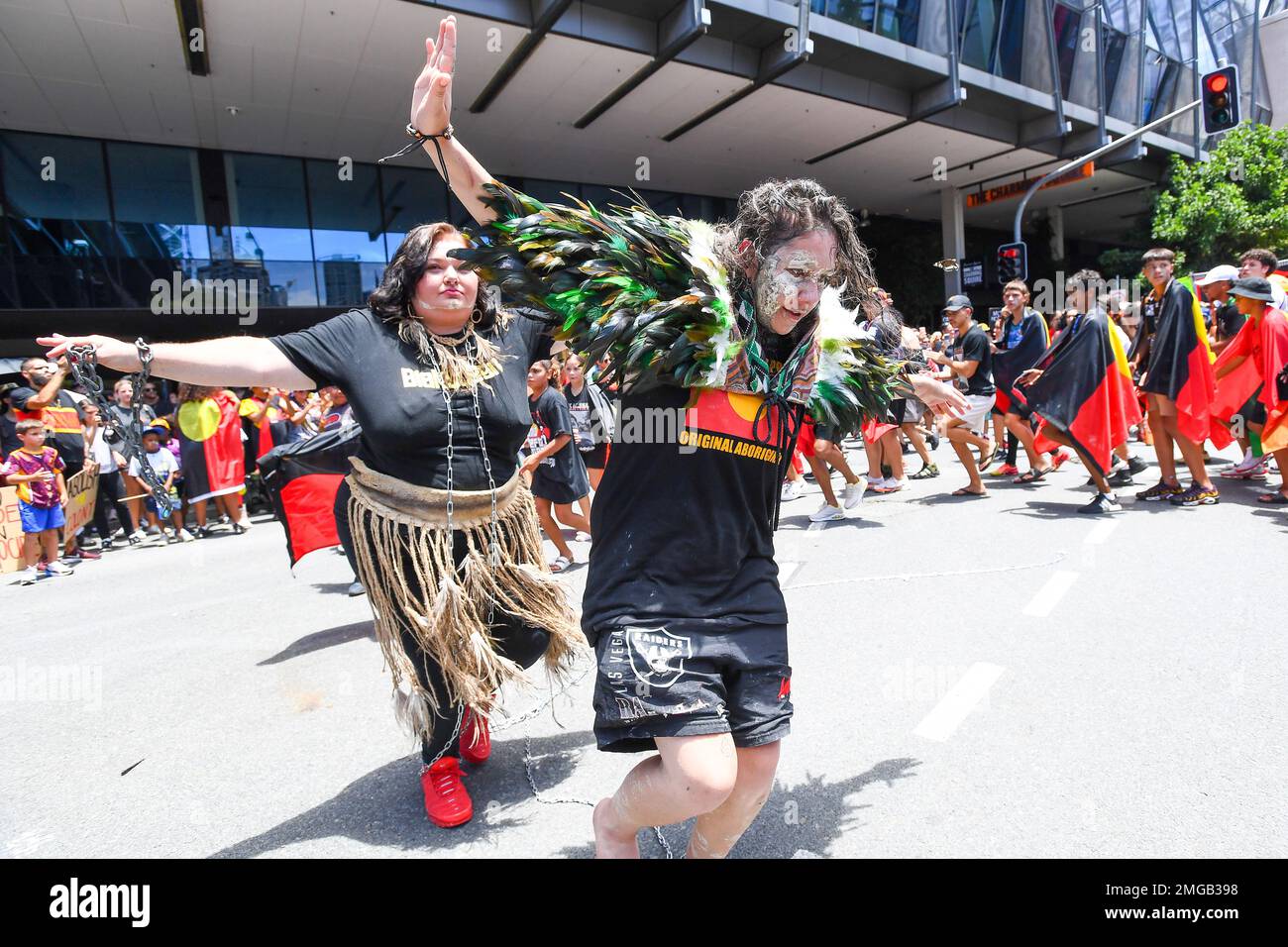 People dance as they march during an Invasion Day rally in Brisbane ...