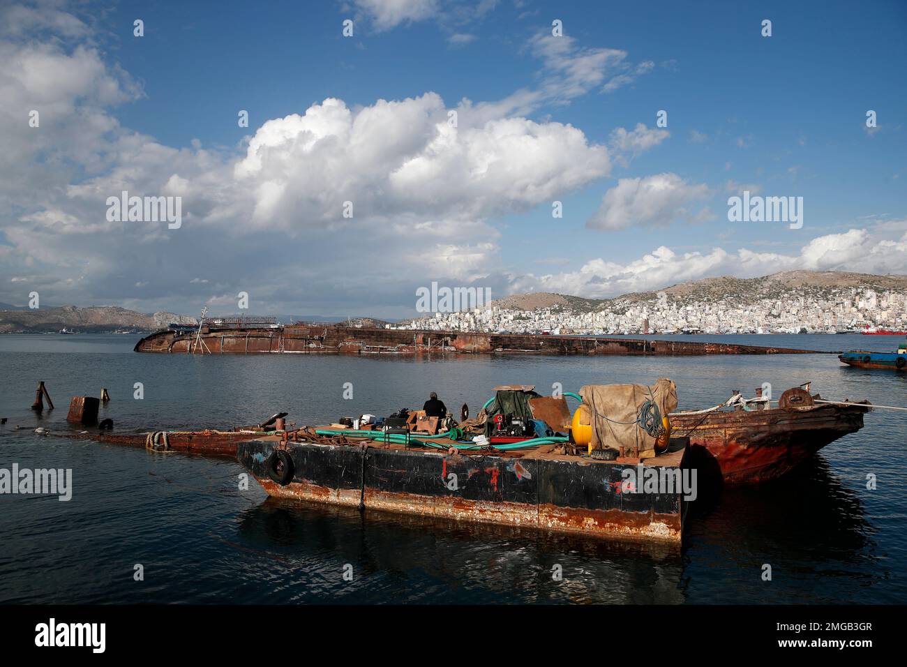 A diver takes a break on a half sunken ship in Damari, an area with ...