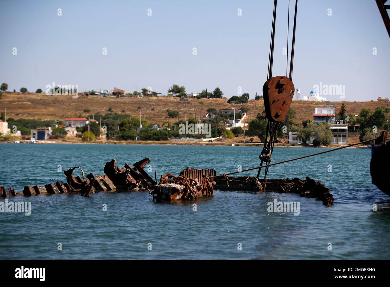 A floating crane holds a shipwreck before the raising operation on ...
