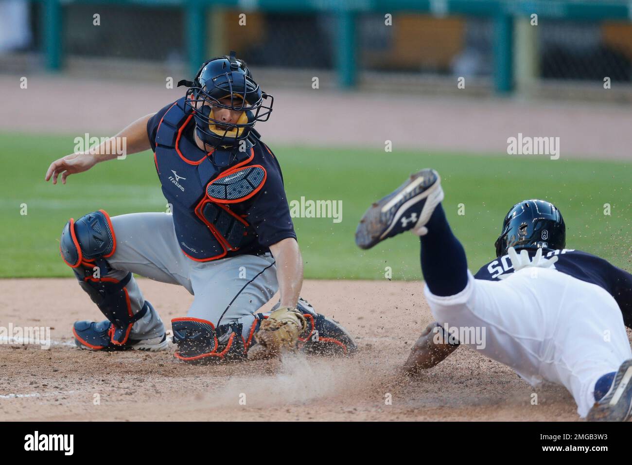 Detroit Tigers' Jonathan Schoop beats the tag of catcher Jake Rogers to ...