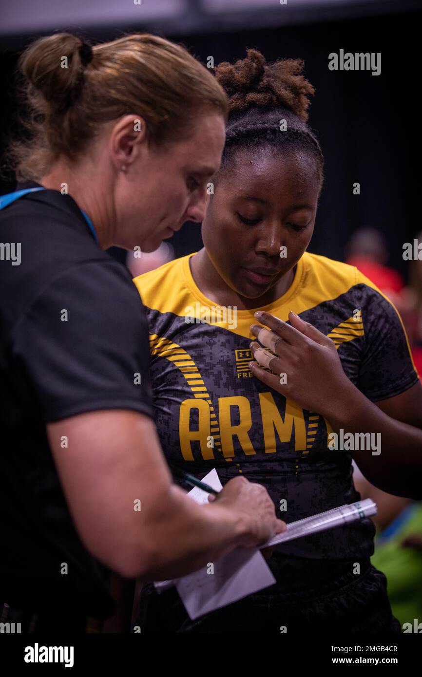 Team Army coach Adriane Wilson, left, and Cpl. Tiffanie Johnson review ...