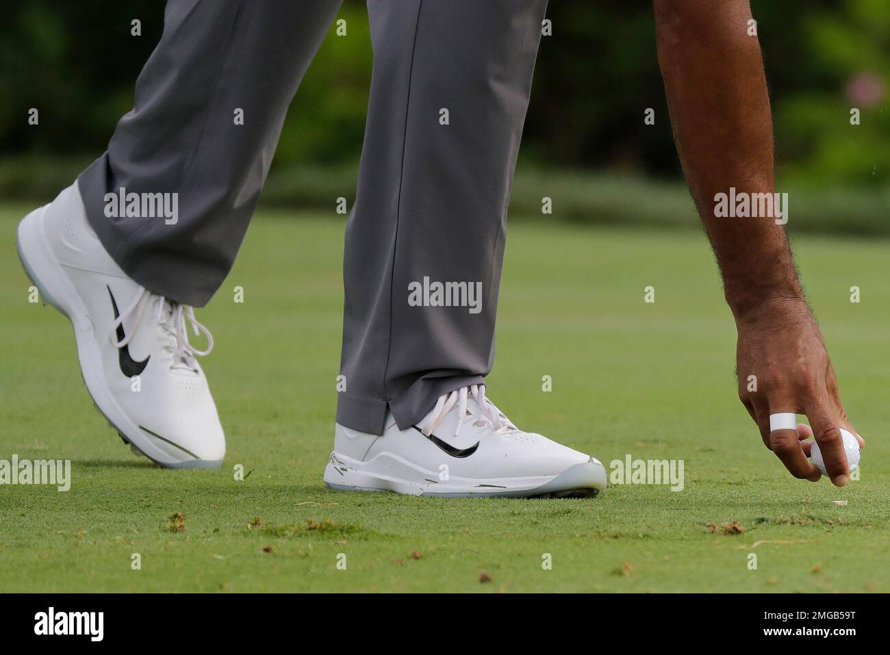 Tiger Woods places his ball at the 14th tee during the second round of ...