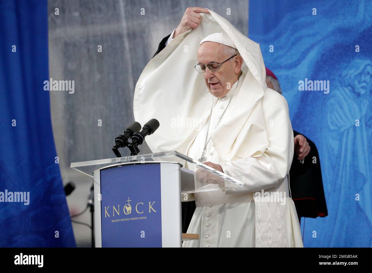 FILE - In this Aug. 26, 2018 file photo, an aide adjusts Pope Francis ...