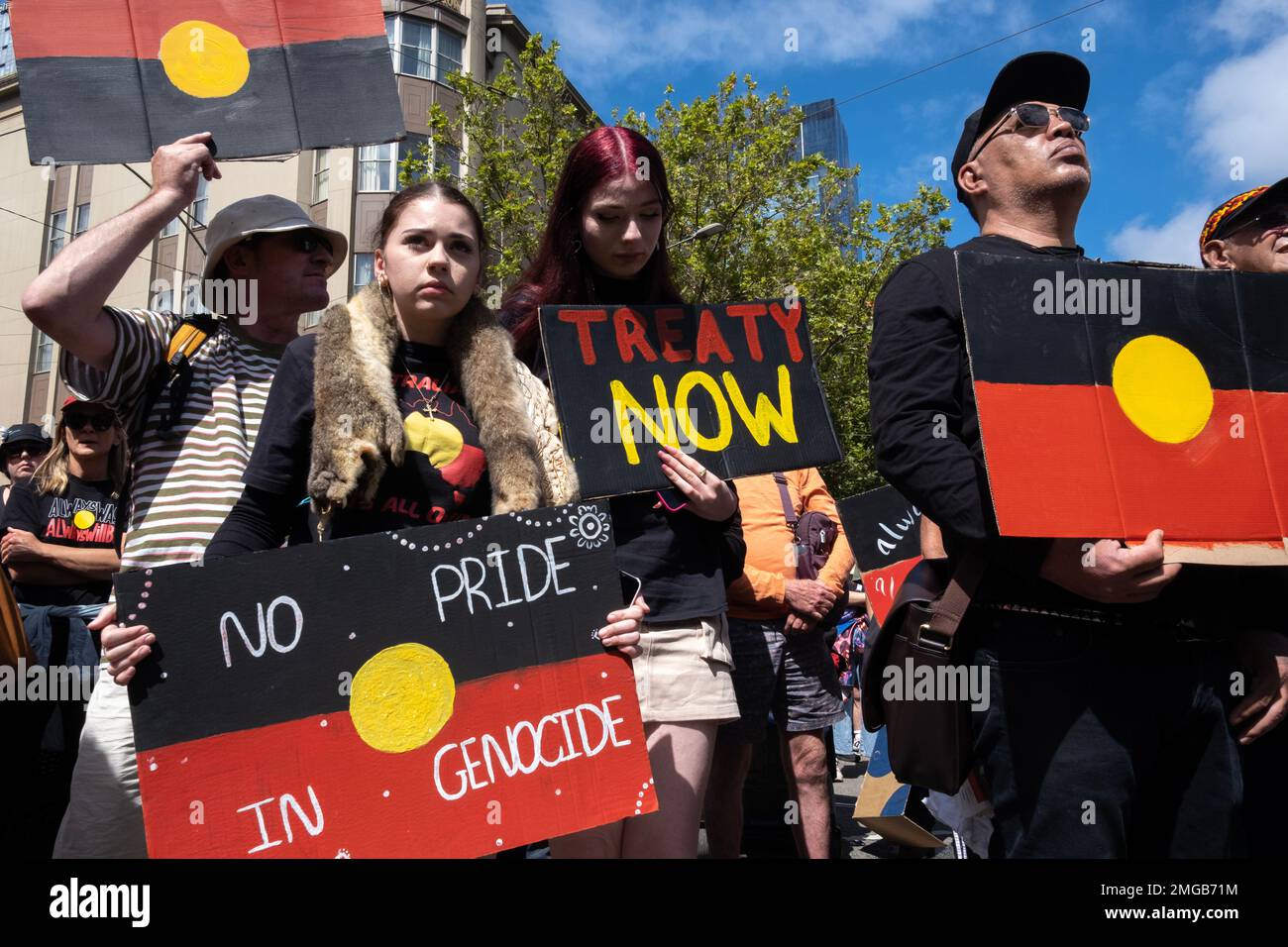 Demonstrators hold placards at the Invasion Day rally in Melbourne ...