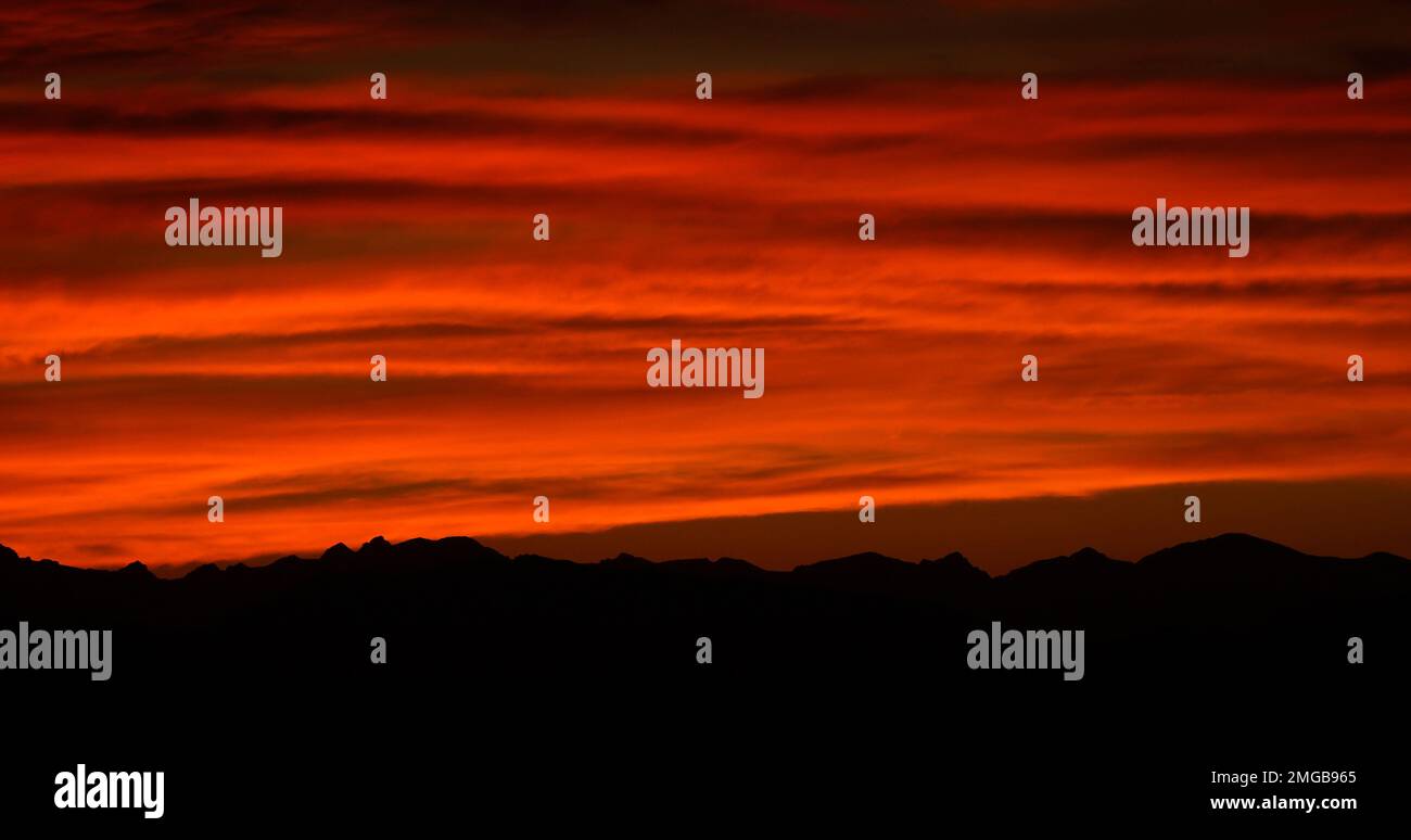The sky is illuminated after the sun set behind the Rocky Mountains ...