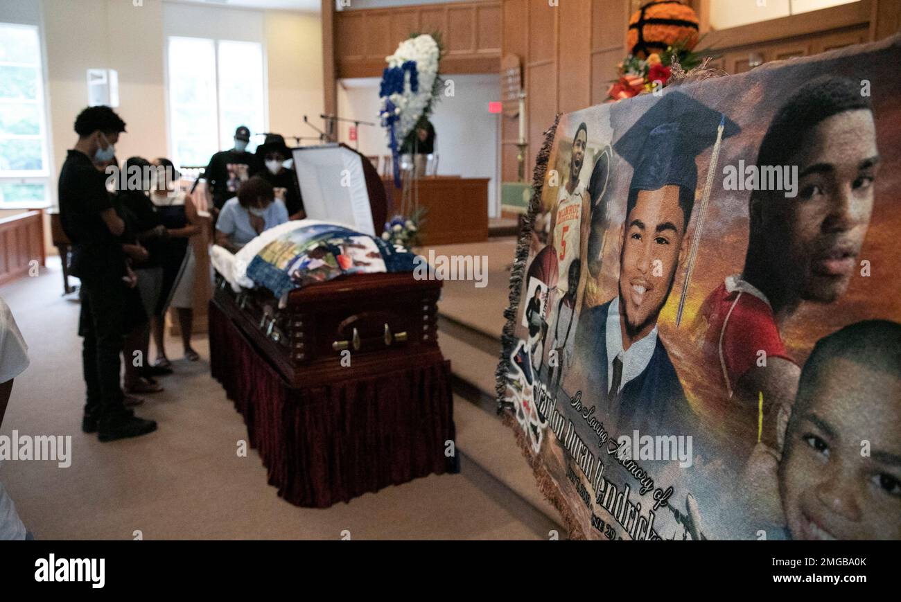 Mourners stand by the casket bearing Brandon Hendricks-Ellison at his ...