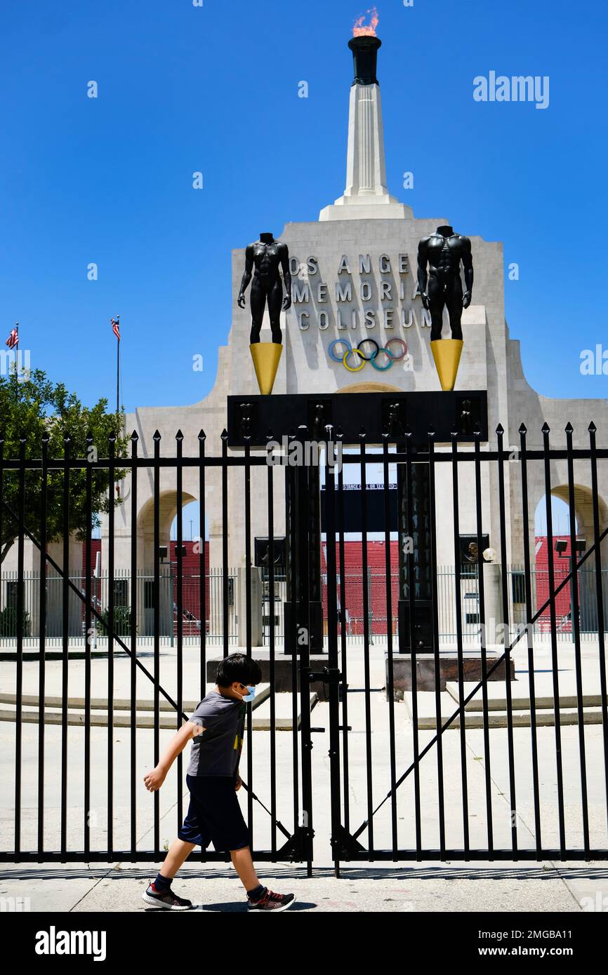 A pedestrian walk by the front of the Los Angeles Memorial Coliseum on ...