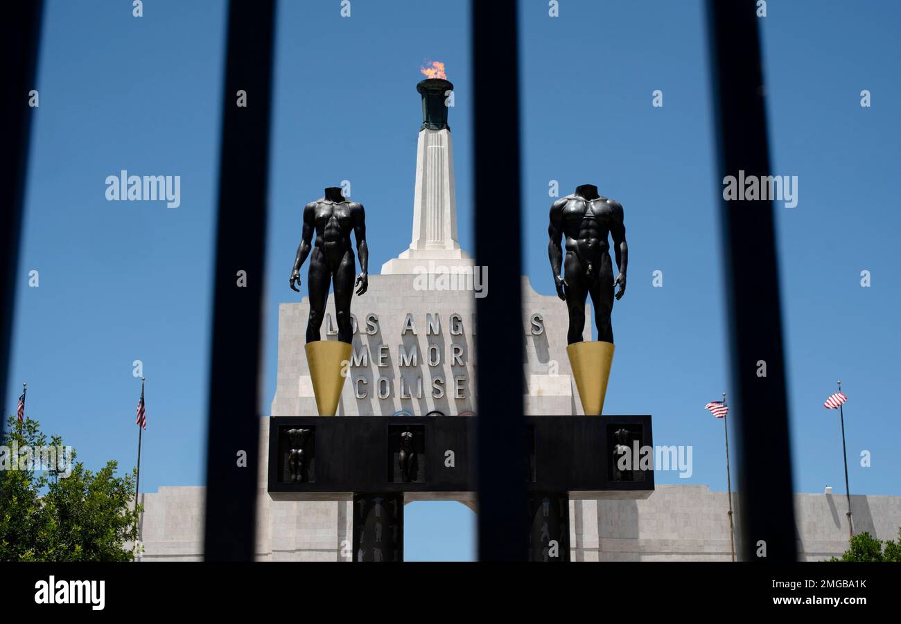The Olympic torch is seen in the front of the Los Angeles Memorial ...