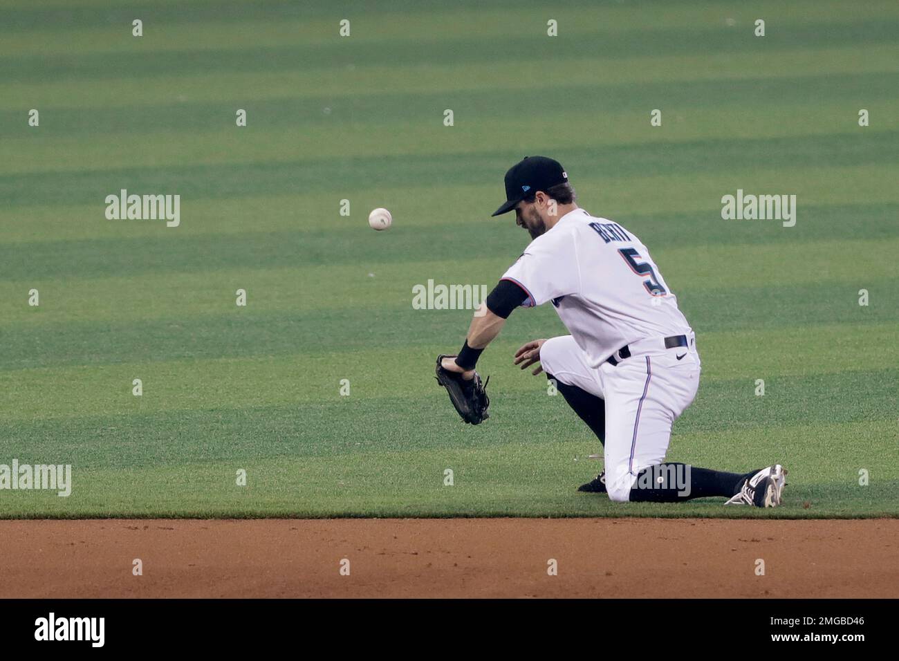 Miami Marlins' Jon Berti is unable to catch a ball hit by Jesus Aguilar ...