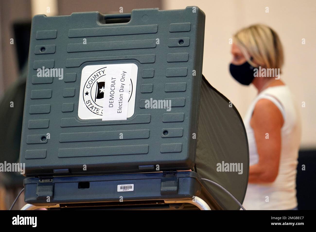 A voter walks past a voting booth before casts her ballot, Tuesday ...