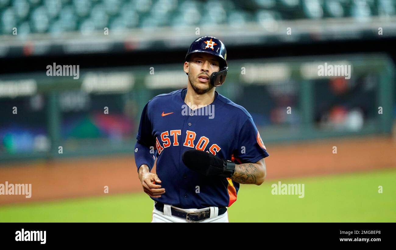 Houston Astros' Carlos Correa scores during an intrasquad baseball game ...