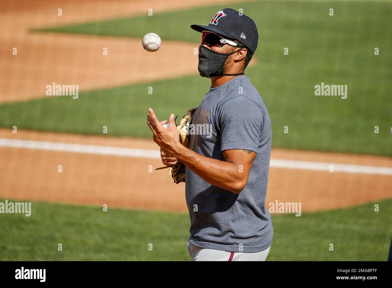 Minnesota Twins' LaMonte Wade tosses a ball at a baseball practice ...