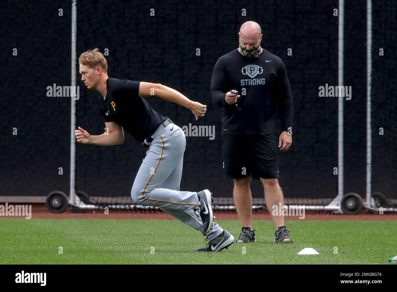 Pittsburgh Pirates pitcher Kyle Crick, left, runs wind sprints as a ...