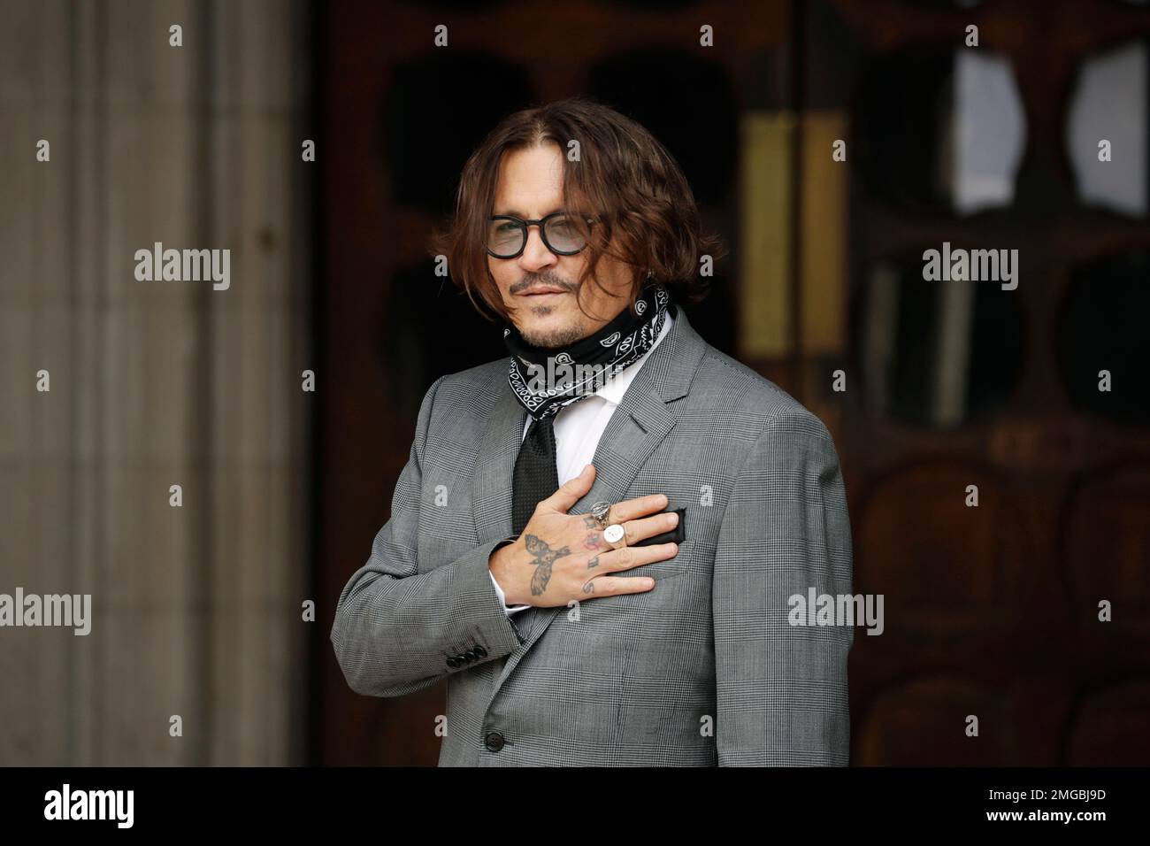 American actor Johnny Depp poses for the media as he arrives at the High Court in London, Monday ...