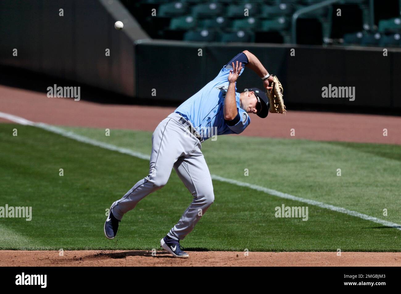 Seattle Mariners first baseman Evan White lunges out of the way of a ...